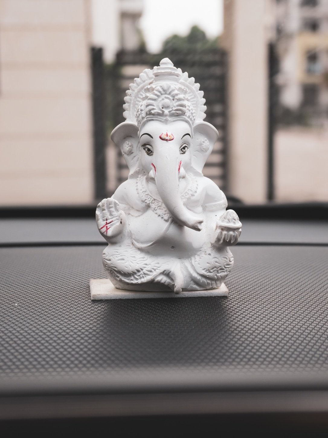 Close up of Lord Ganesh small statue in white colour - pepiko